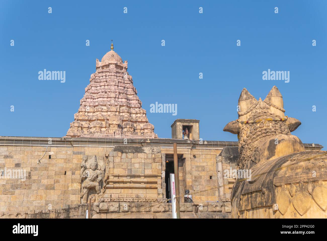 Nandhi facingthe shiva temple gopuram in an ancient south Indian temple ...