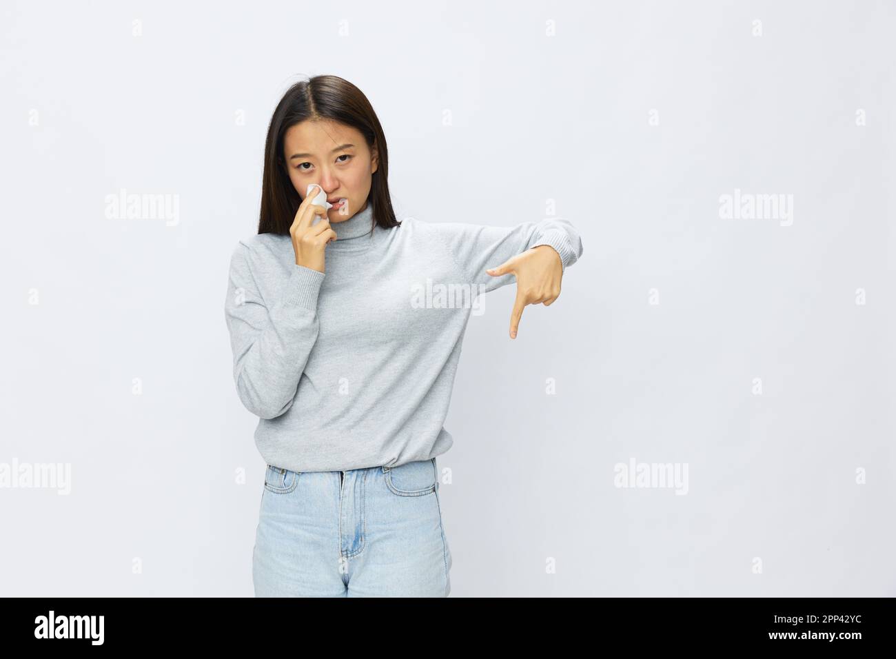Asian woman holding hand with handkerchief and coughing up flu and cold ...