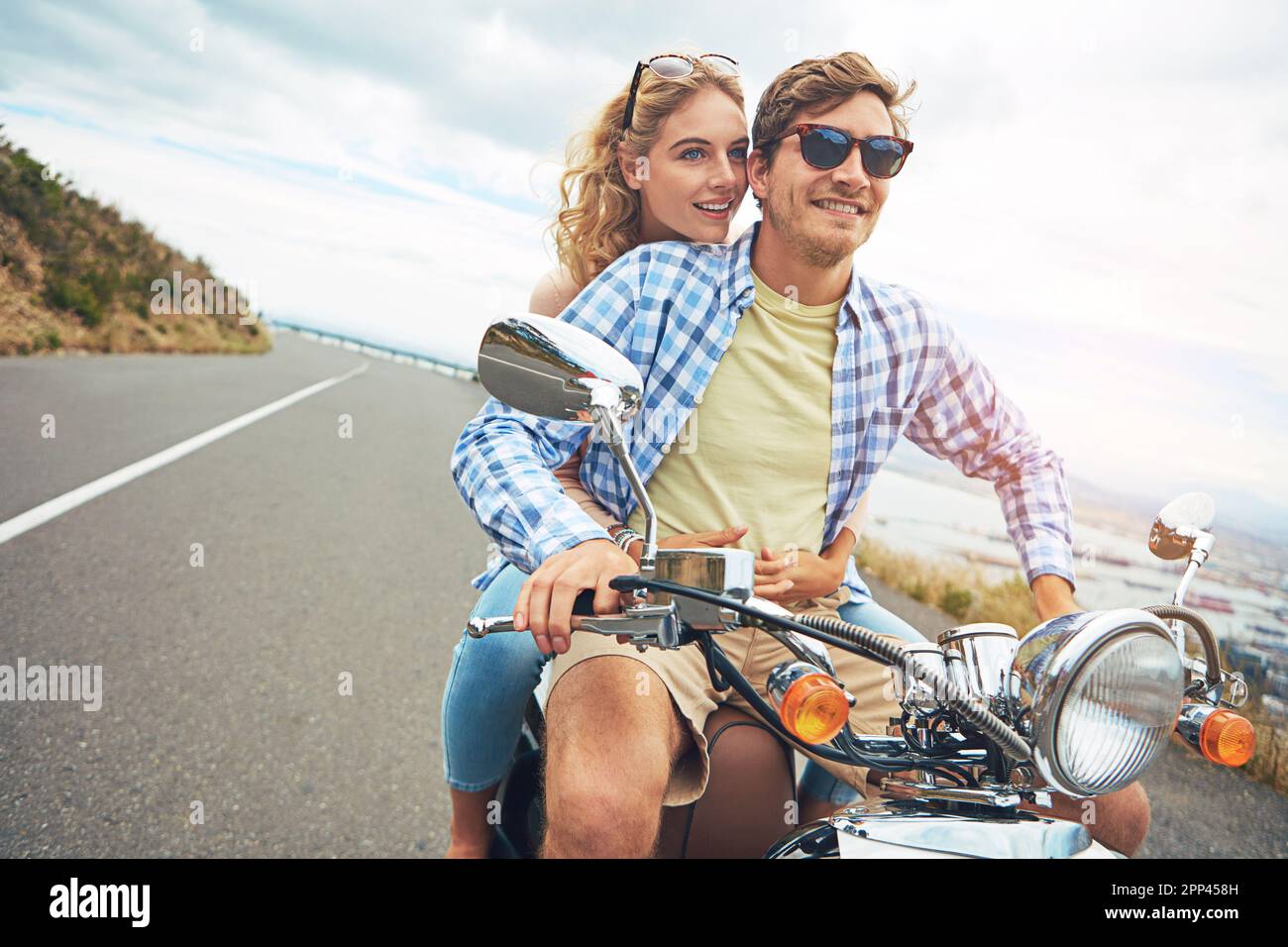Hitting the open road. a young couple out for a ride on a scooter Stock ...