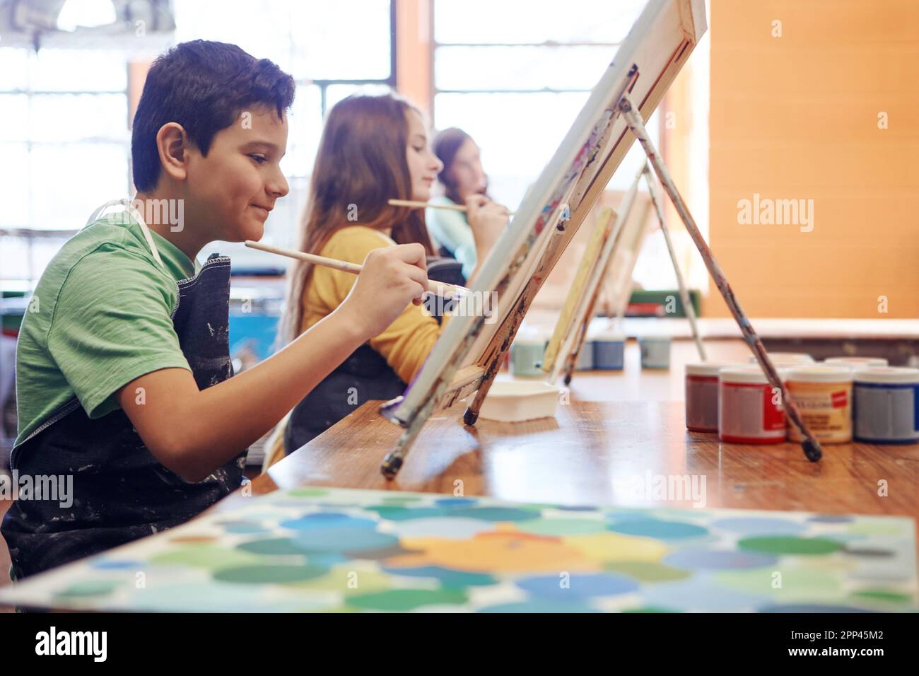 Tapping into his creativity. a young schoolboy in an art class Stock ...