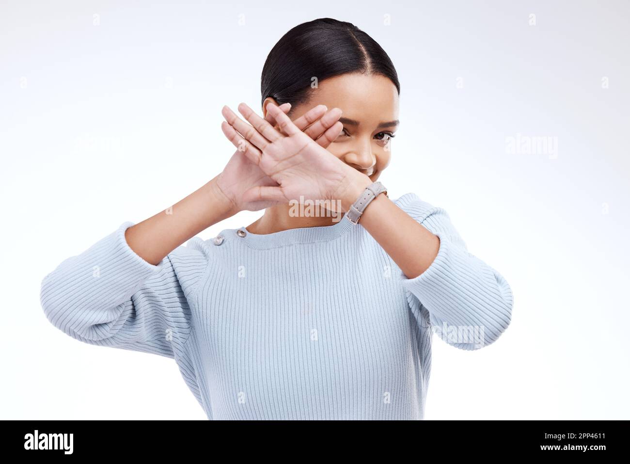 Stop, hands and woman portrait in a studio showing palm and hiding with ...