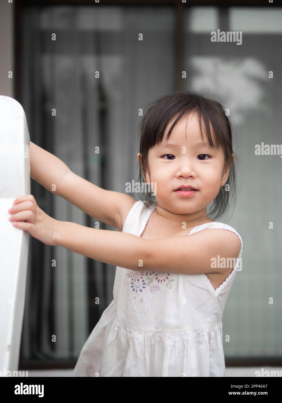 Adorable little girl playing peekaboo, asian child Stock Photo - Alamy