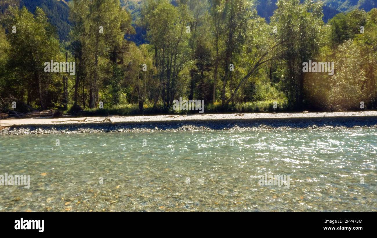 tiny clear cold river with shingle rocks in Arkhyz mountain ridge ...