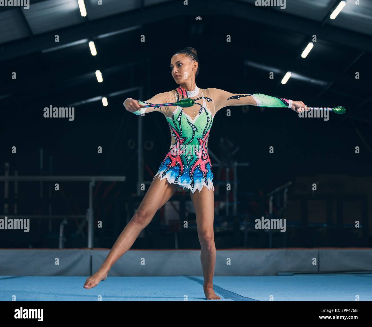 Woman, gymnastics and sticks in gym for training, dancing and ...
