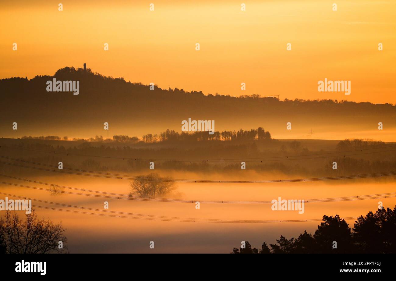 Ertingen, Germany. 22nd Apr, 2023. The rising sun colors the sky and ...