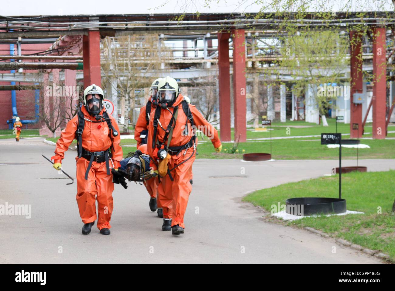 Three professional firefighter firefighters in orange protective ...