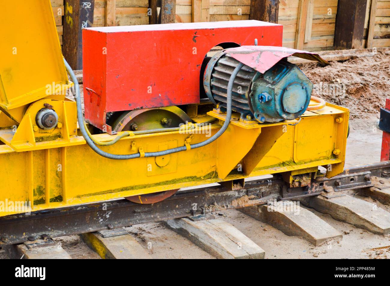 Large iron metal yellow supports on rails with wheels with an induction ...