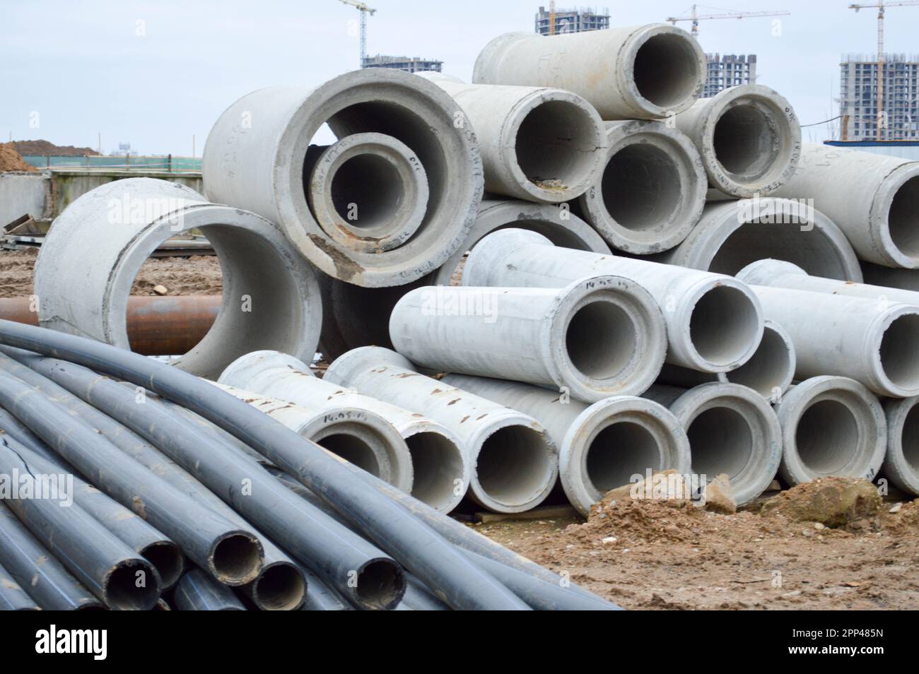 Large black plastic and concrete stone cement sewer plumbing pipes for ...