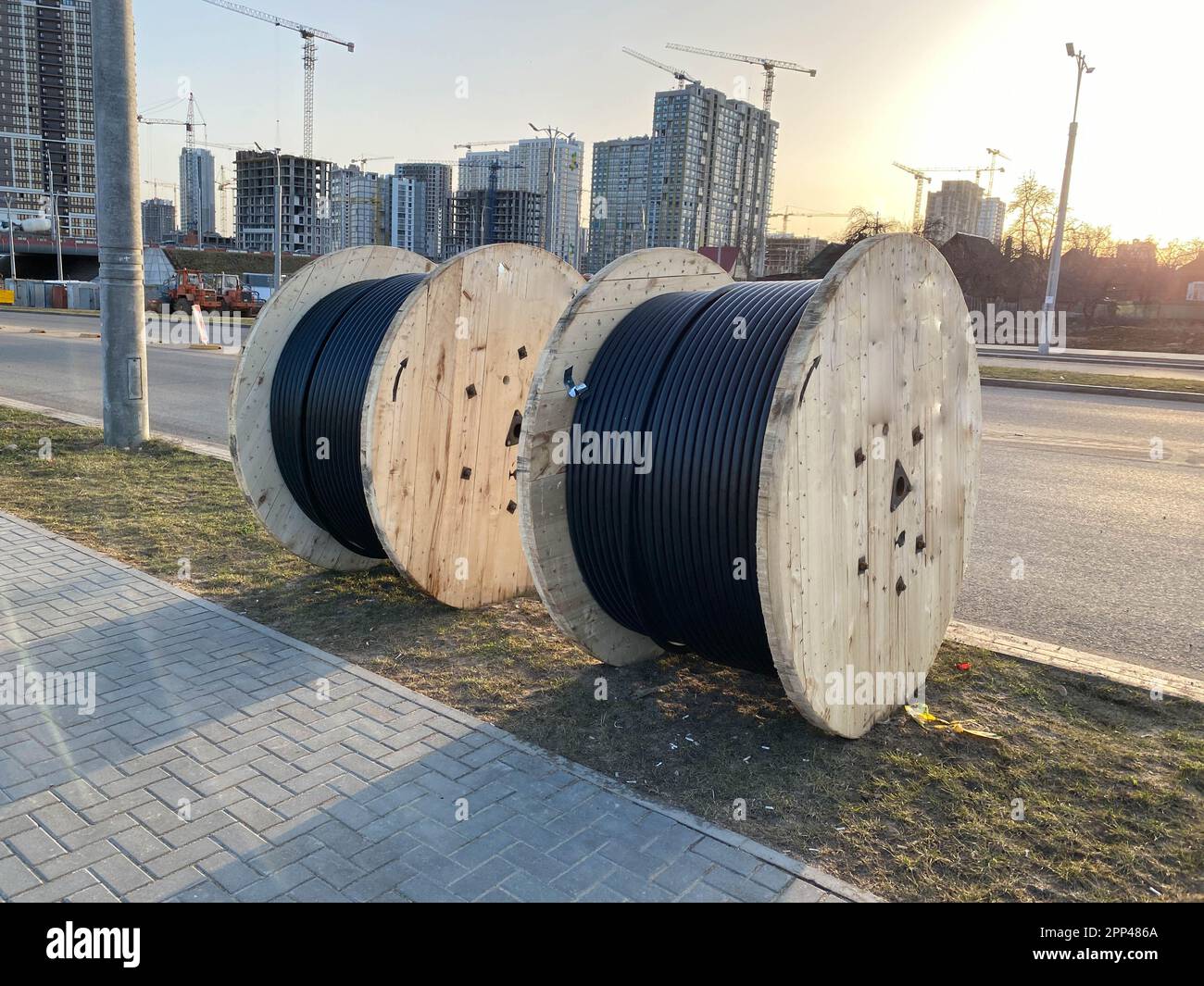 Wooden Coils Of Electrical wire Outdoor. High and low voltage cables in ...