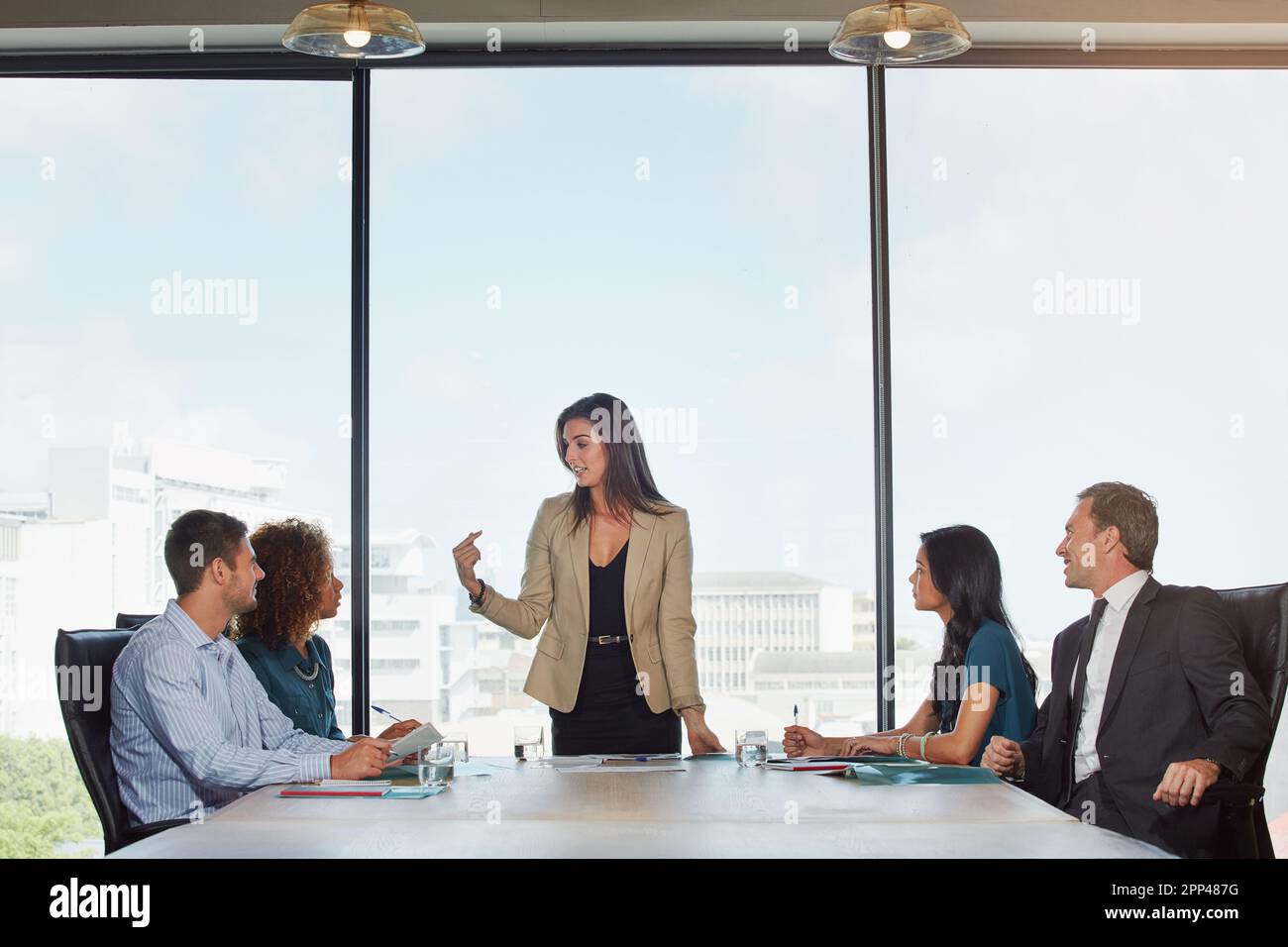 The teams talking strategy. a group of businesspeople in a meeting ...