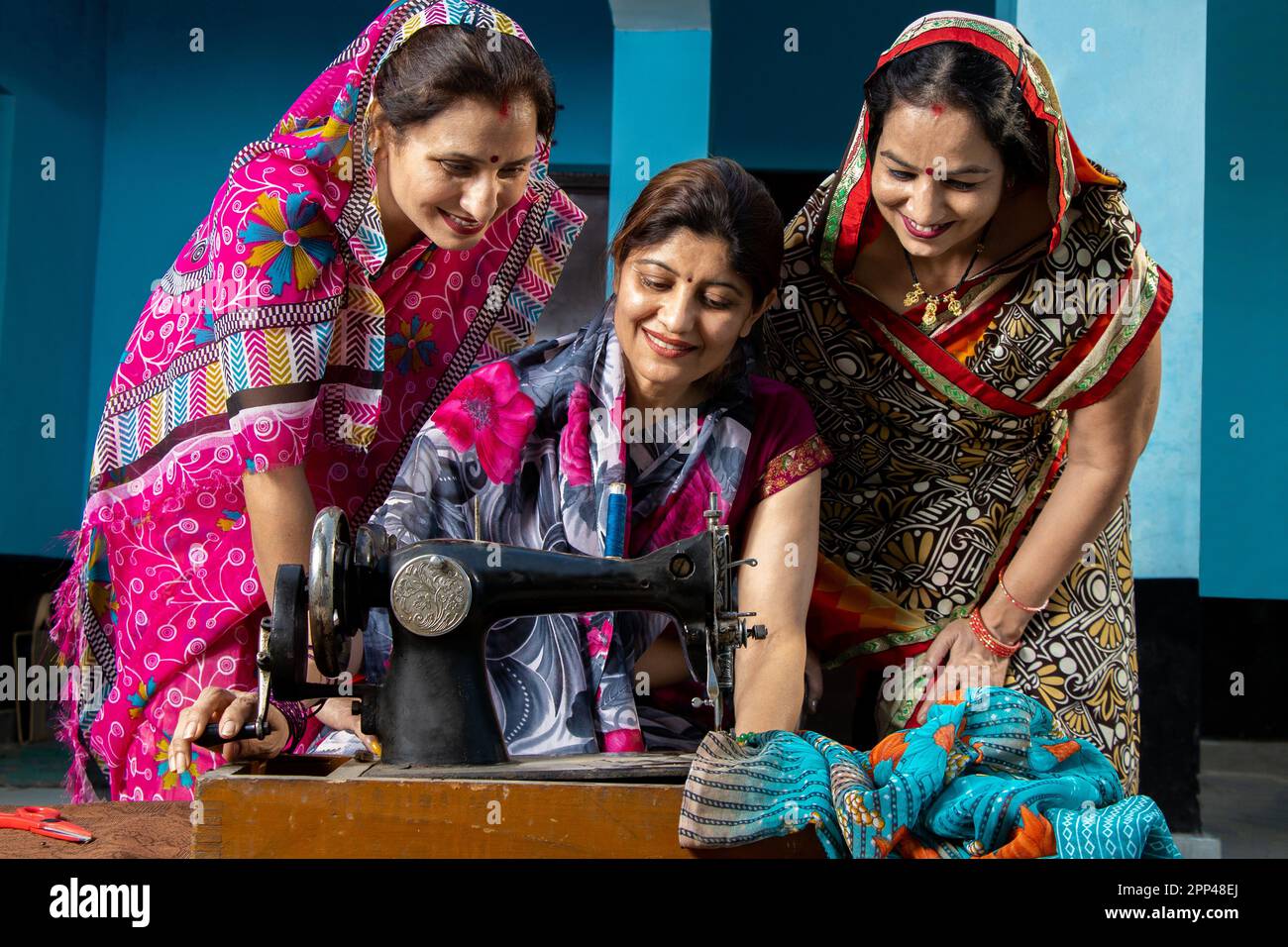 Portrait happy traditional indian woman wearing sari teaching other ...