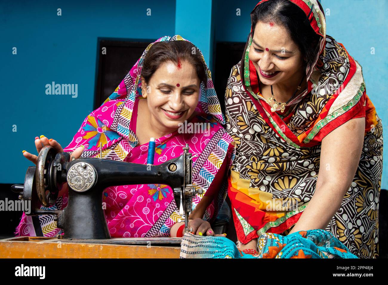 Portrait happy traditional indian woman wearing sari teaching other ...