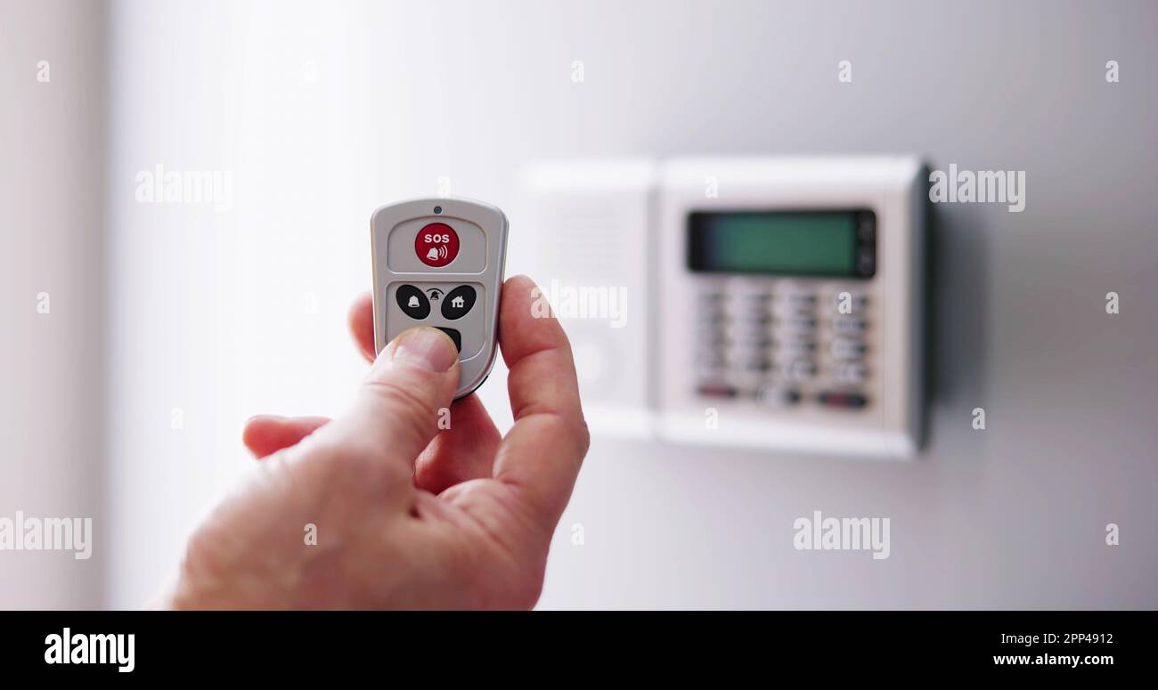 Security Alarm Keypad With Person Arming The System With Remote ...