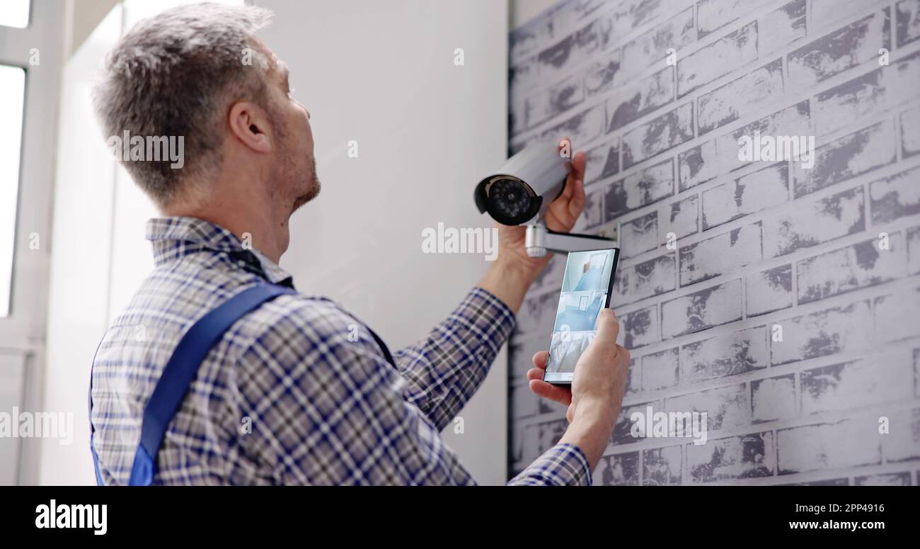 Technician Adjusting CCTV Camera For Video Surveillance Stock Photo - Alamy