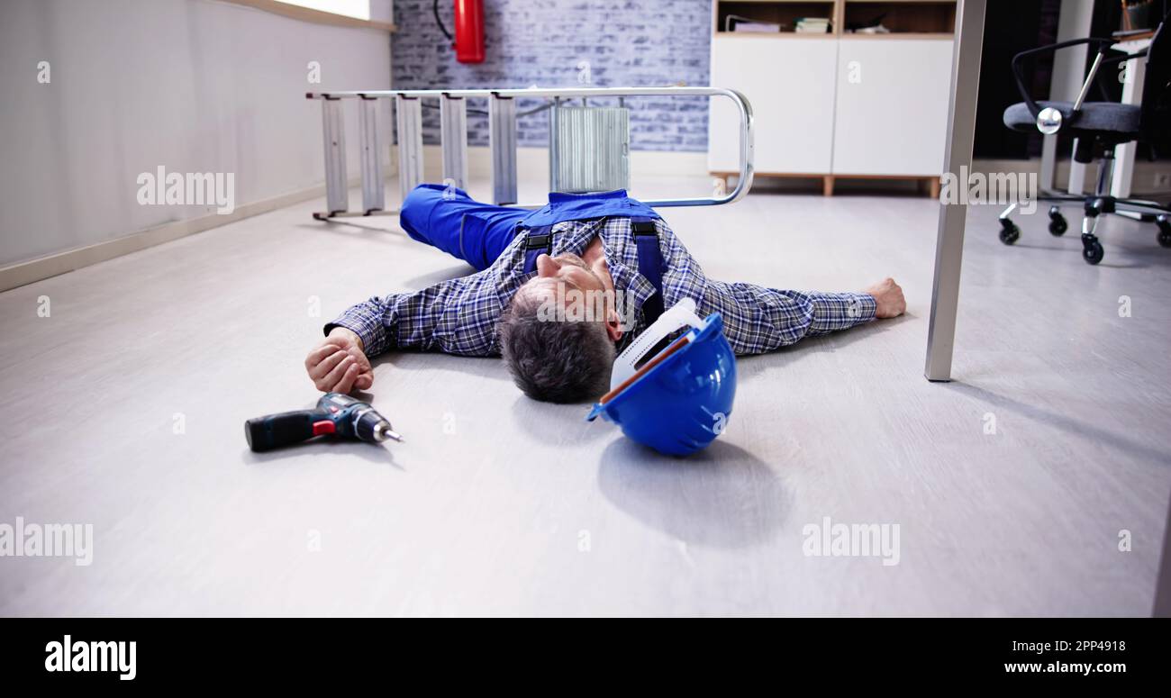 Unconscious Handyman Fallen From Ladder With Equipments Lying On Floor ...