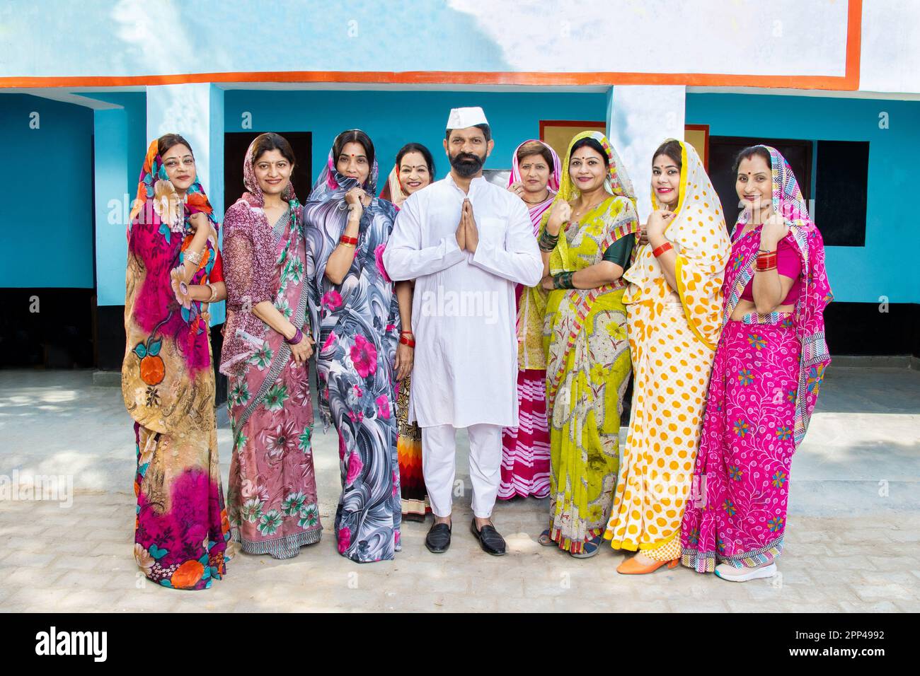 Indian man politician standing doing namaste with group of traditional ...