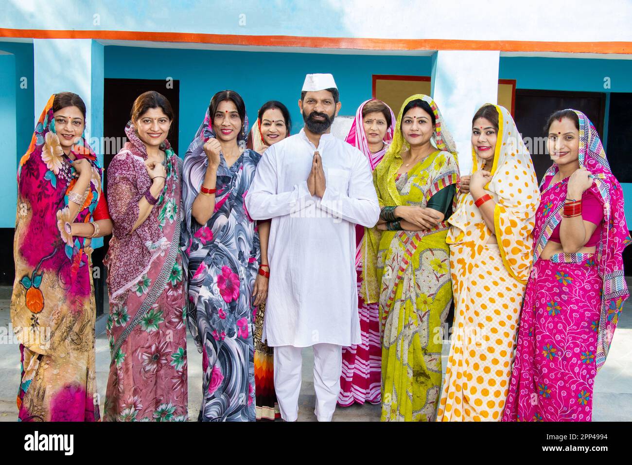 Indian man politician standing doing namaste with group of traditional ...