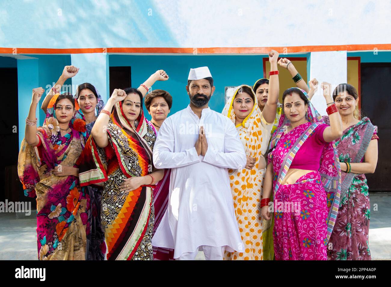 Indian man politician standing doing namaste with group of traditional ...