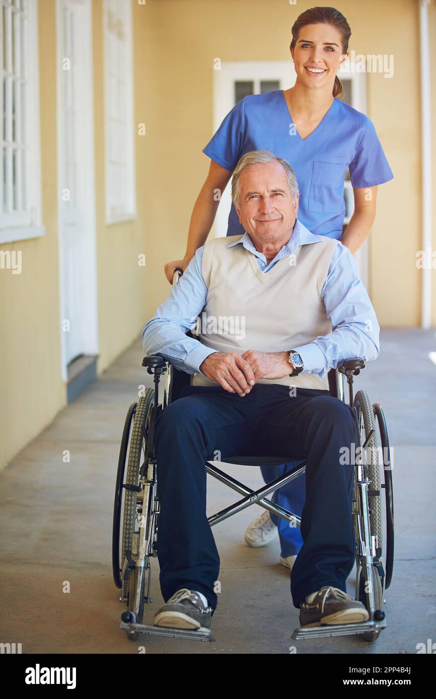 Committed to his comfort and care. a doctor pushing her senior patient ...