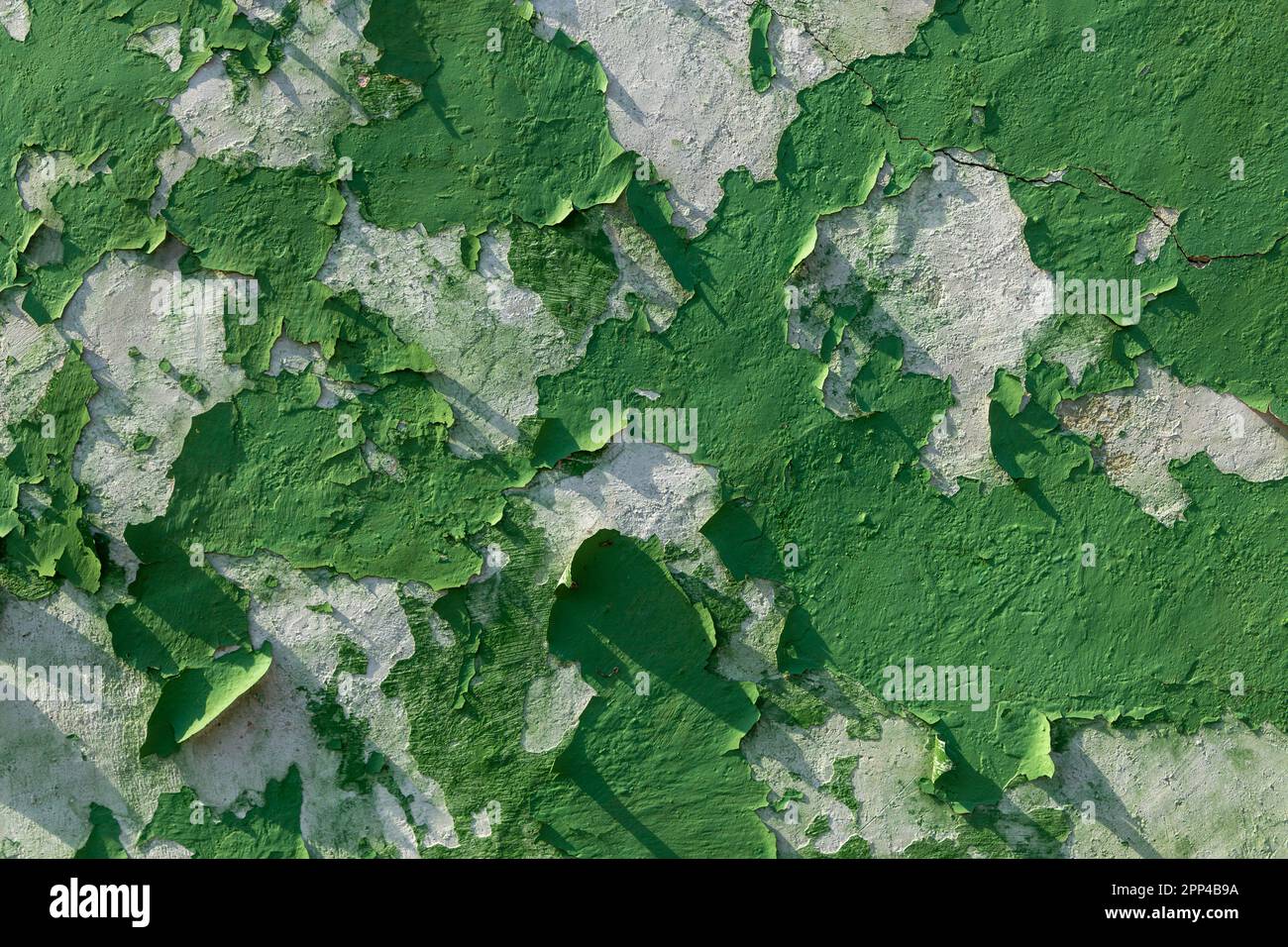 Badly fixed building facade wall covered with cracks in stucco and ...