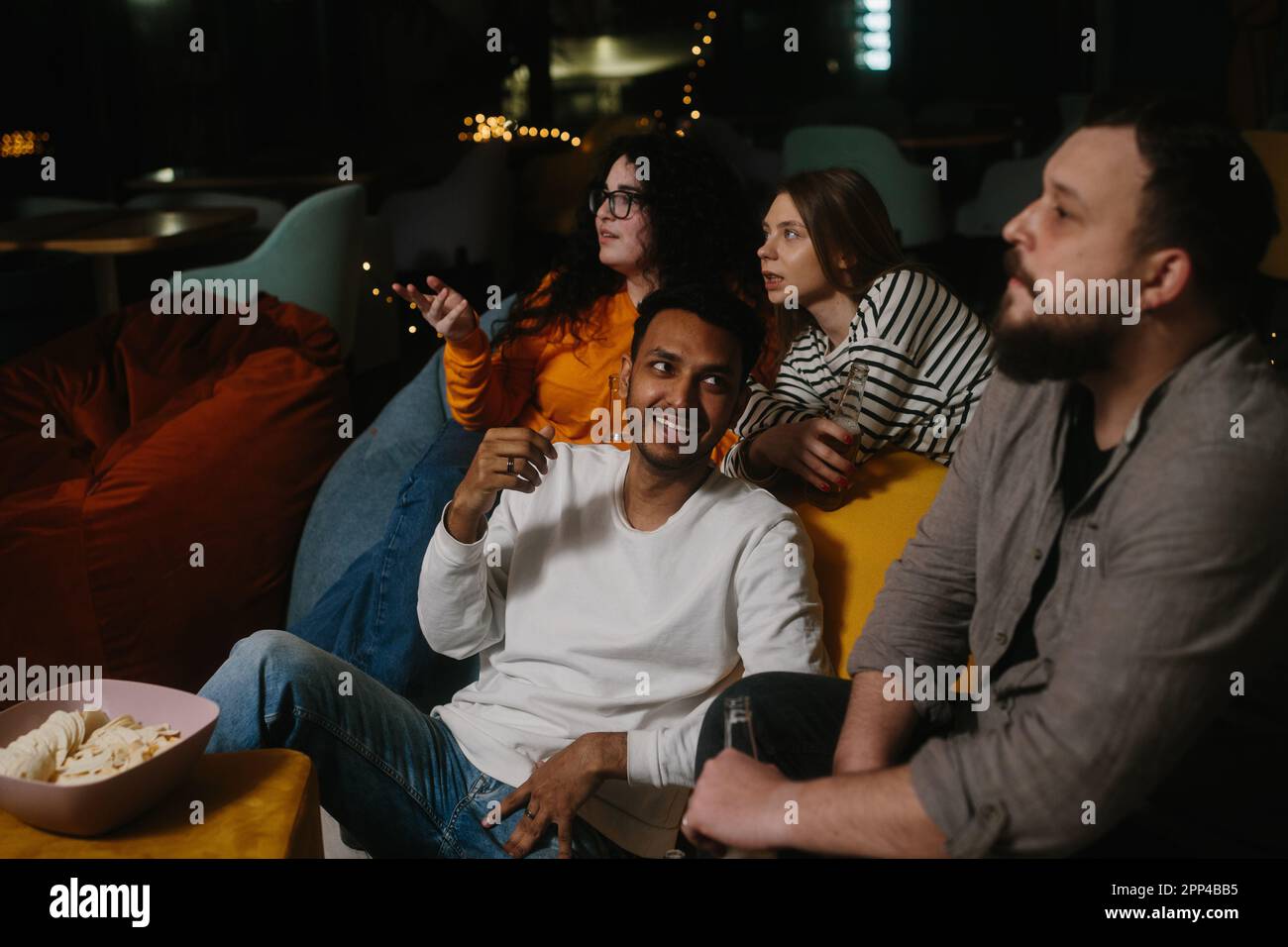 Cheerful young people watching a movie in a cafe Stock Photo - Alamy