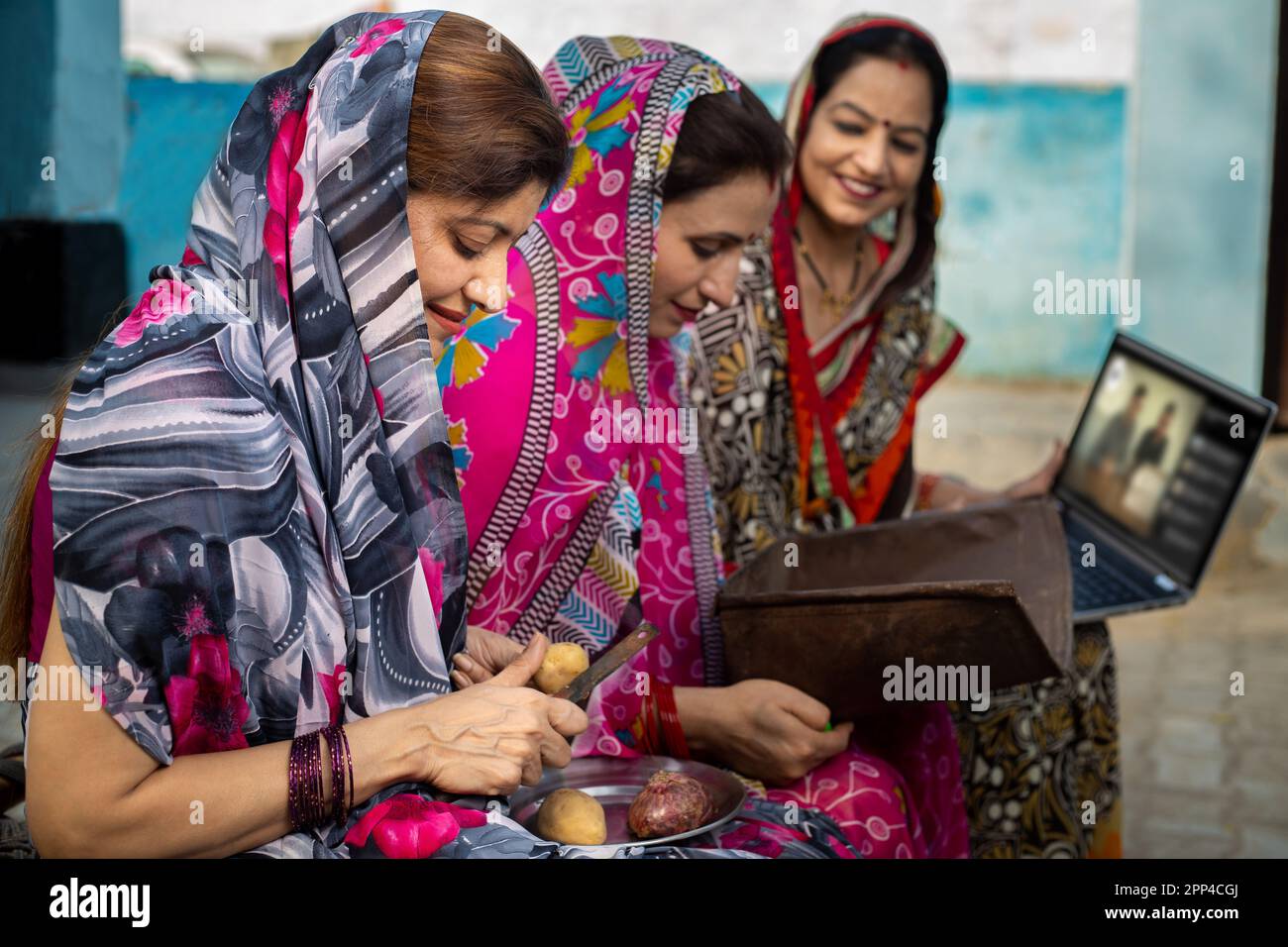 Group of traditional married indian women wearing sari do household ...