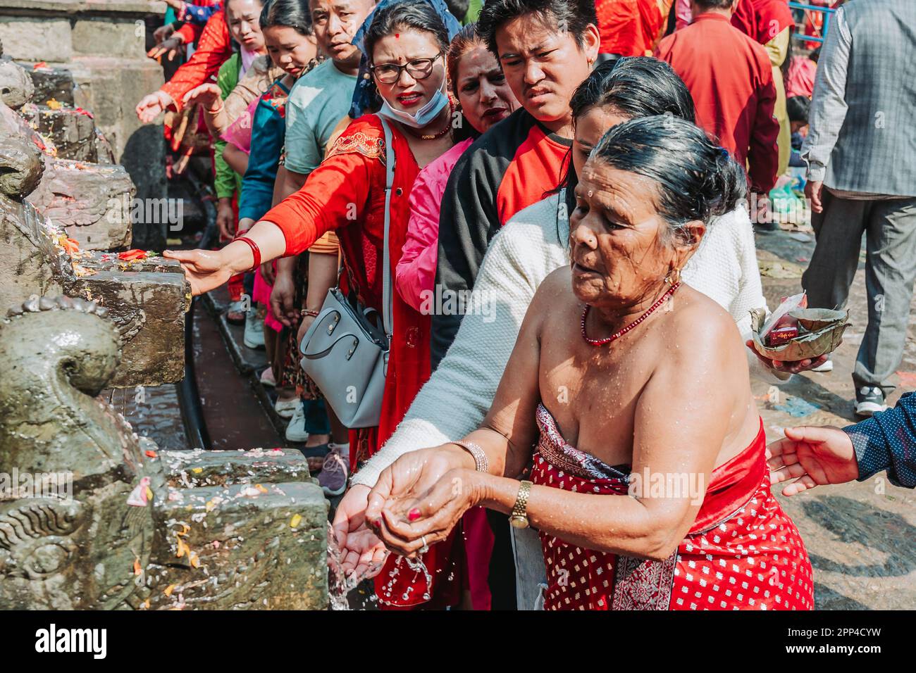 kathmandu, Nepal - April 20, 2023 : Devoted Hindu people taking a holy ...