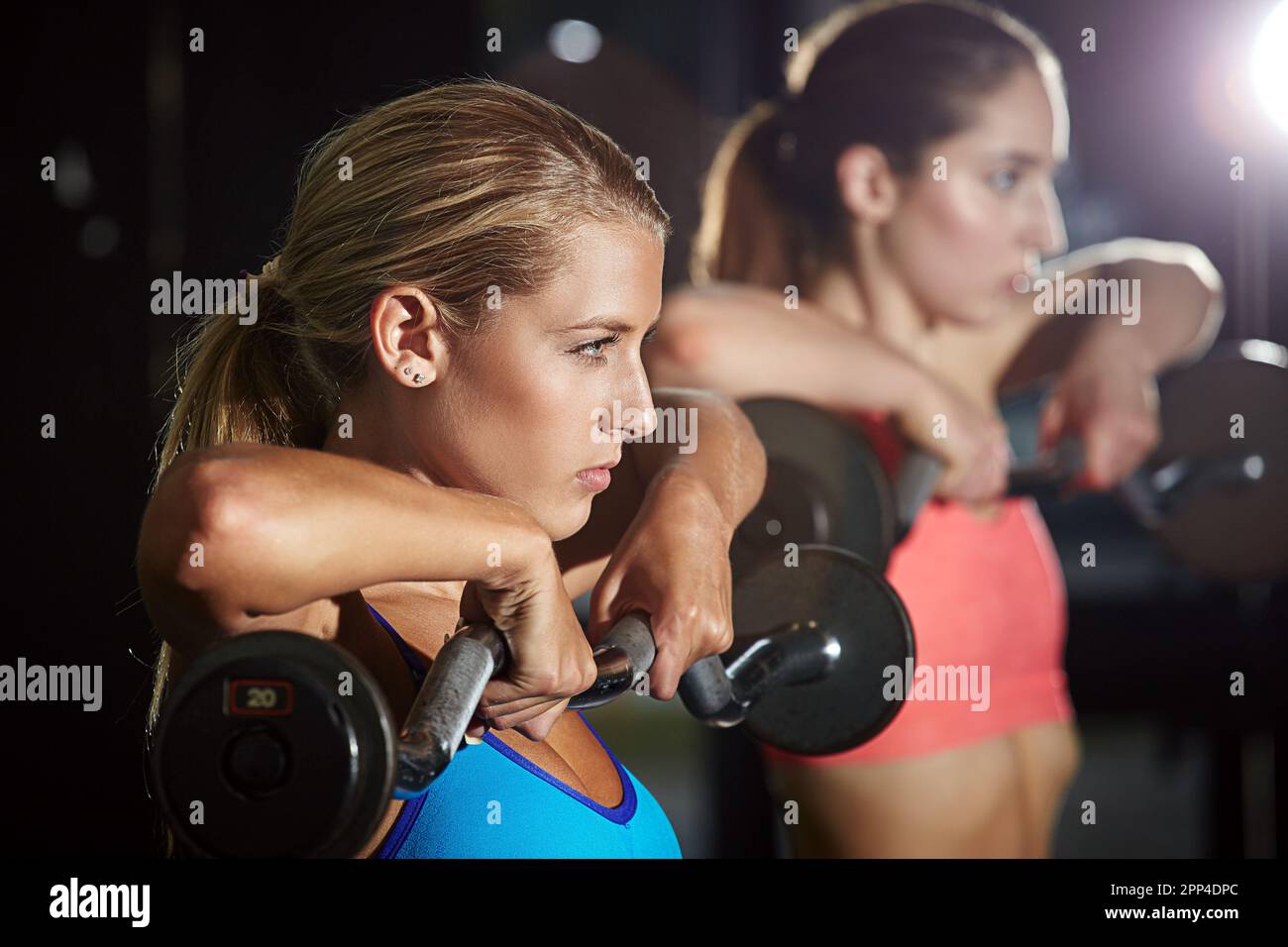 Powering through their workout. two young women working out with ...