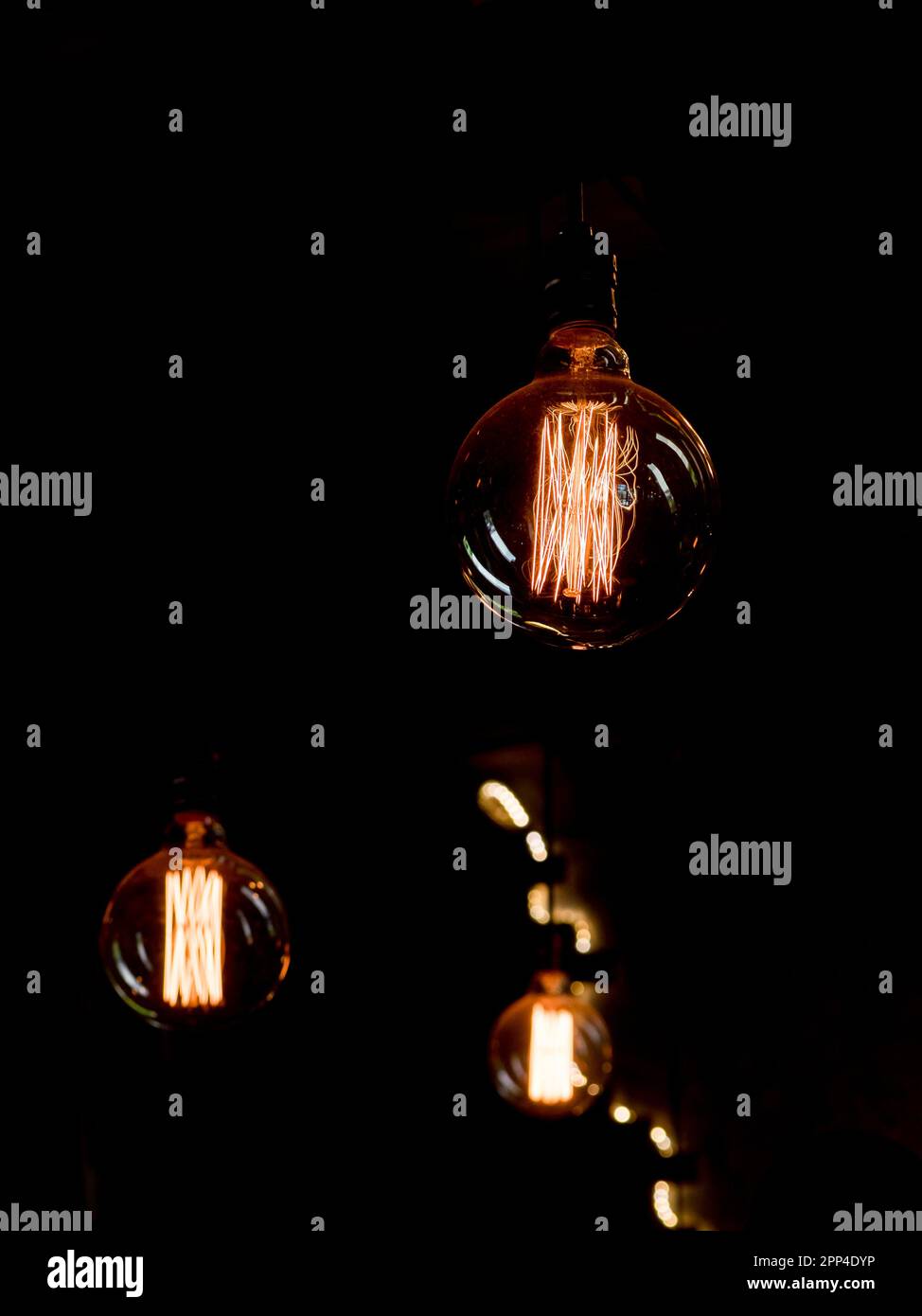 Vintage incandescent light bulb filament on black, close up shot Stock ...