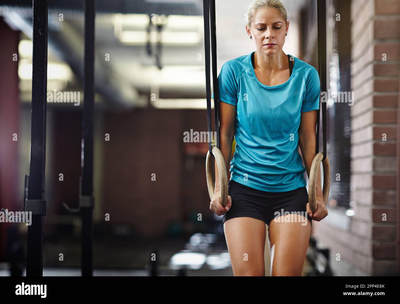 Body and mind over matter. a young woman working out with gymnastics ...