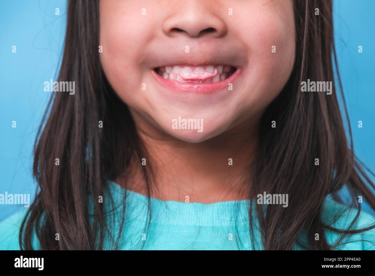 Smiling cute little girl eating sweet gelatin with sugar added isolated ...