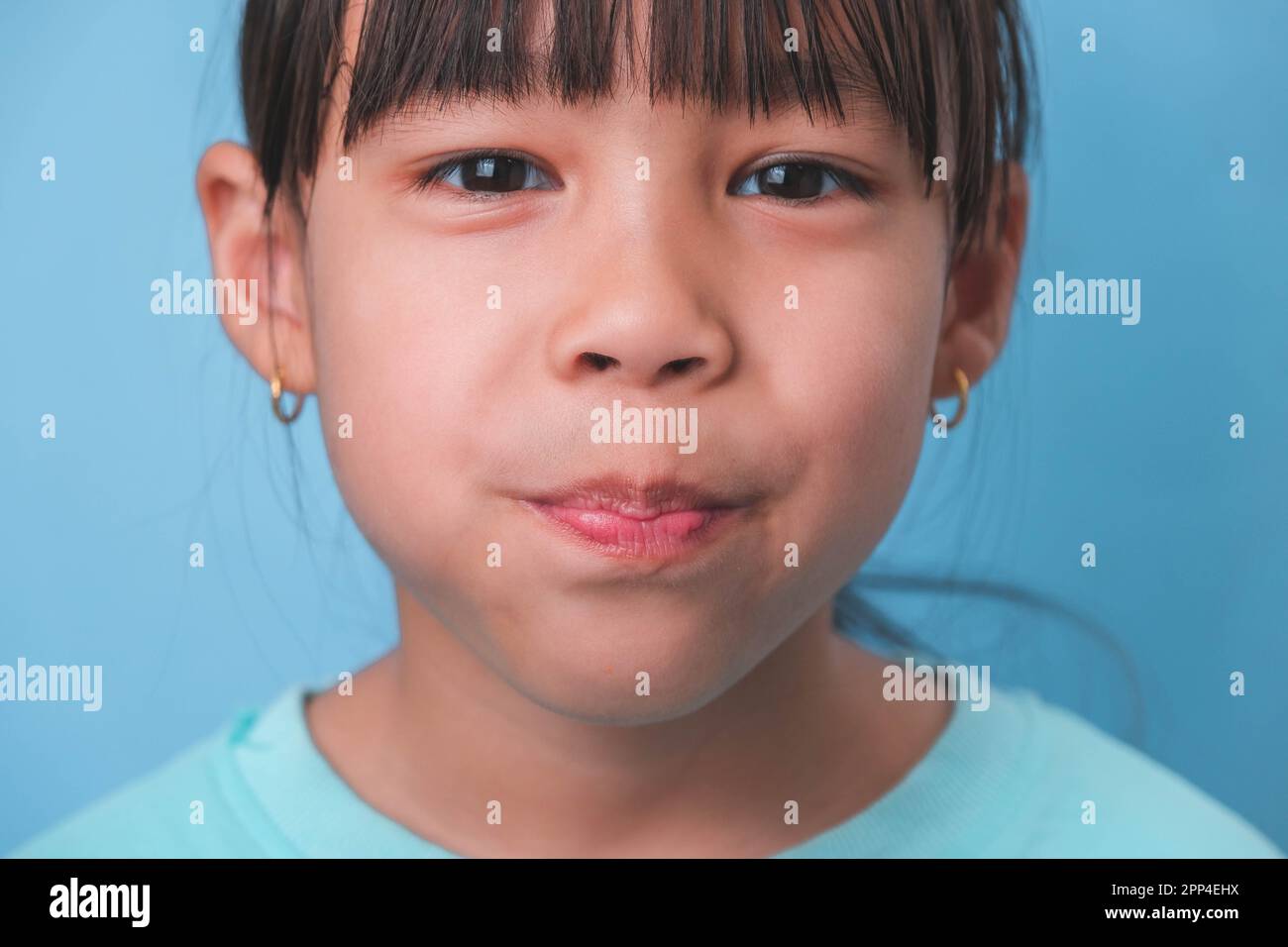 Smiling cute little girl eating sweet gelatin with sugar added isolated ...