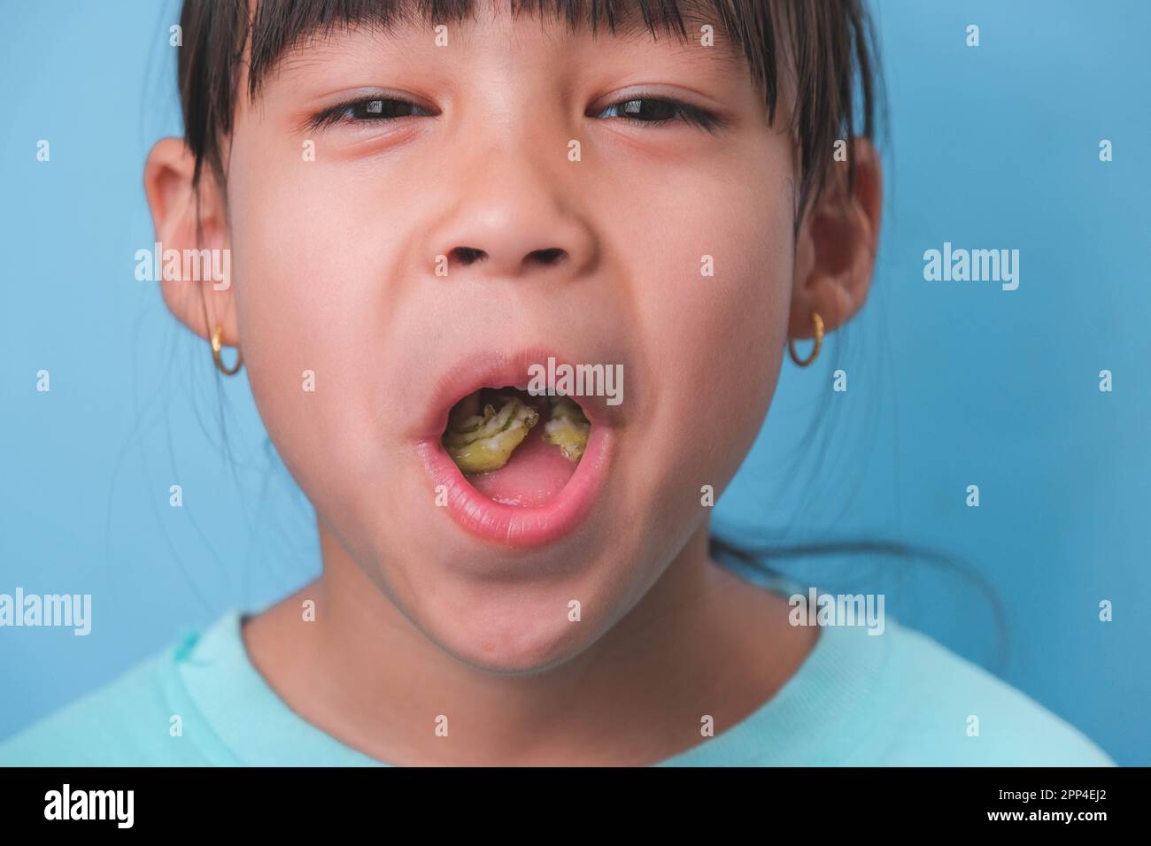 Smiling cute little girl eating sweet gelatin with sugar added isolated ...