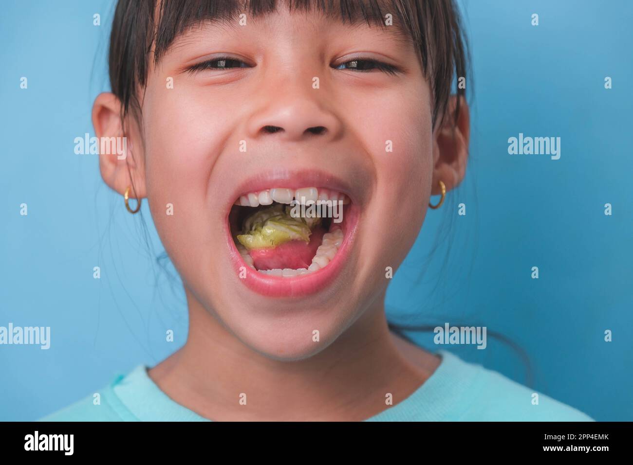 Smiling cute little girl eating sweet gelatin with sugar added isolated ...
