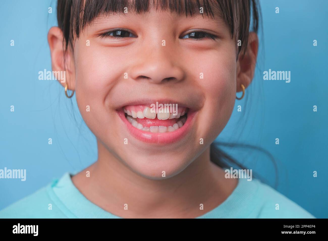 Close-up of smiling young girl revealing her beautiful white teeth on a ...