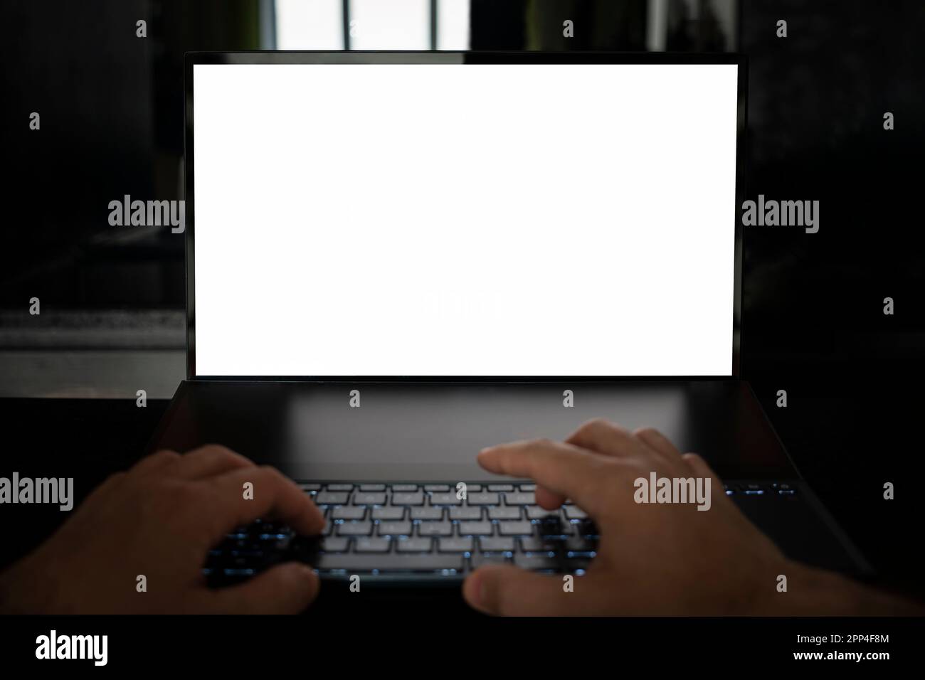 Mockup image of hands using laptop with blank white screen on table on ...
