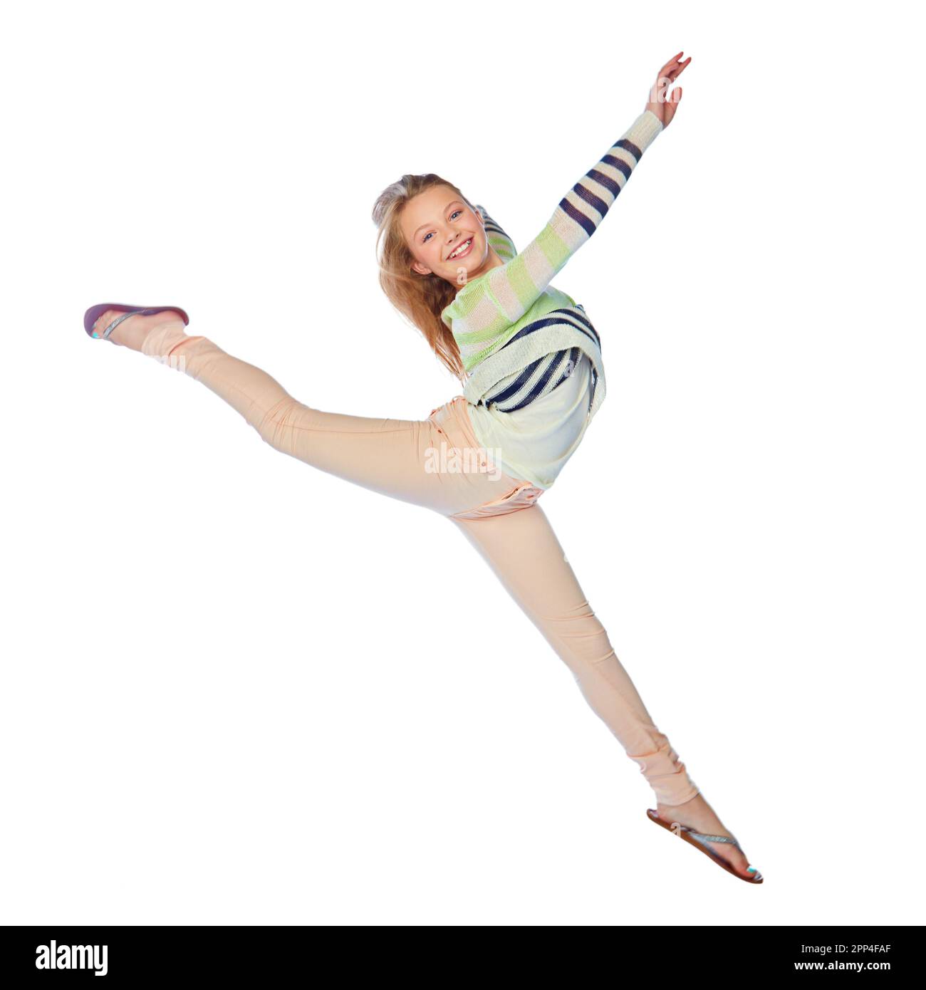 Growing in leaps and bounds. Studio shot of a young girl jumping for ...