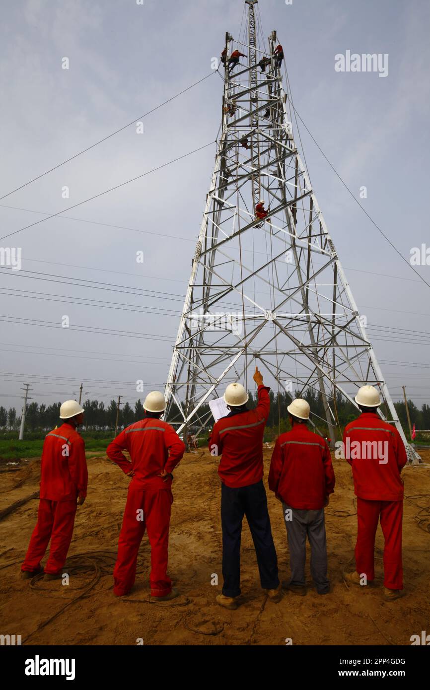The workers of the pylon Stock Photo - Alamy