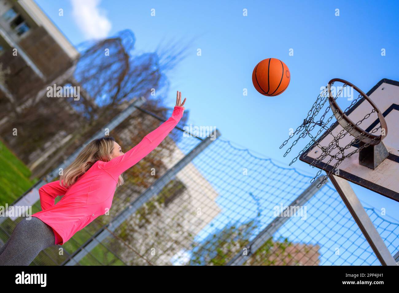 Woman throwing basketball hi-res stock photography and images - Alamy