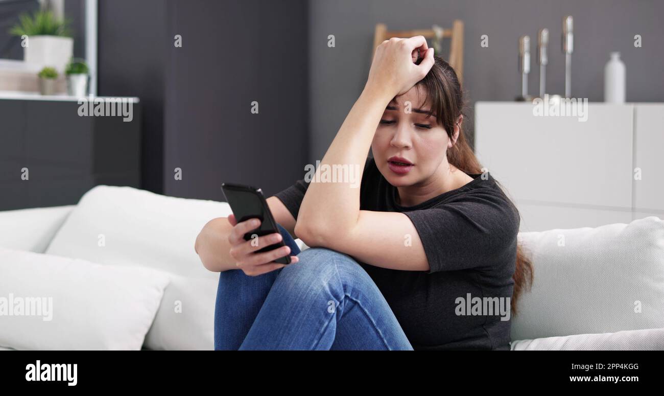 Worried Woman Looking At Anonymous Phone Call Stock Photo - Alamy