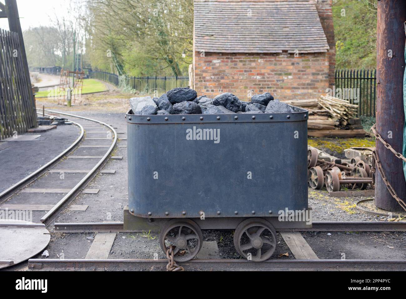 factory coal tub or trolley on tracks filled with coal Stock Photo - Alamy
