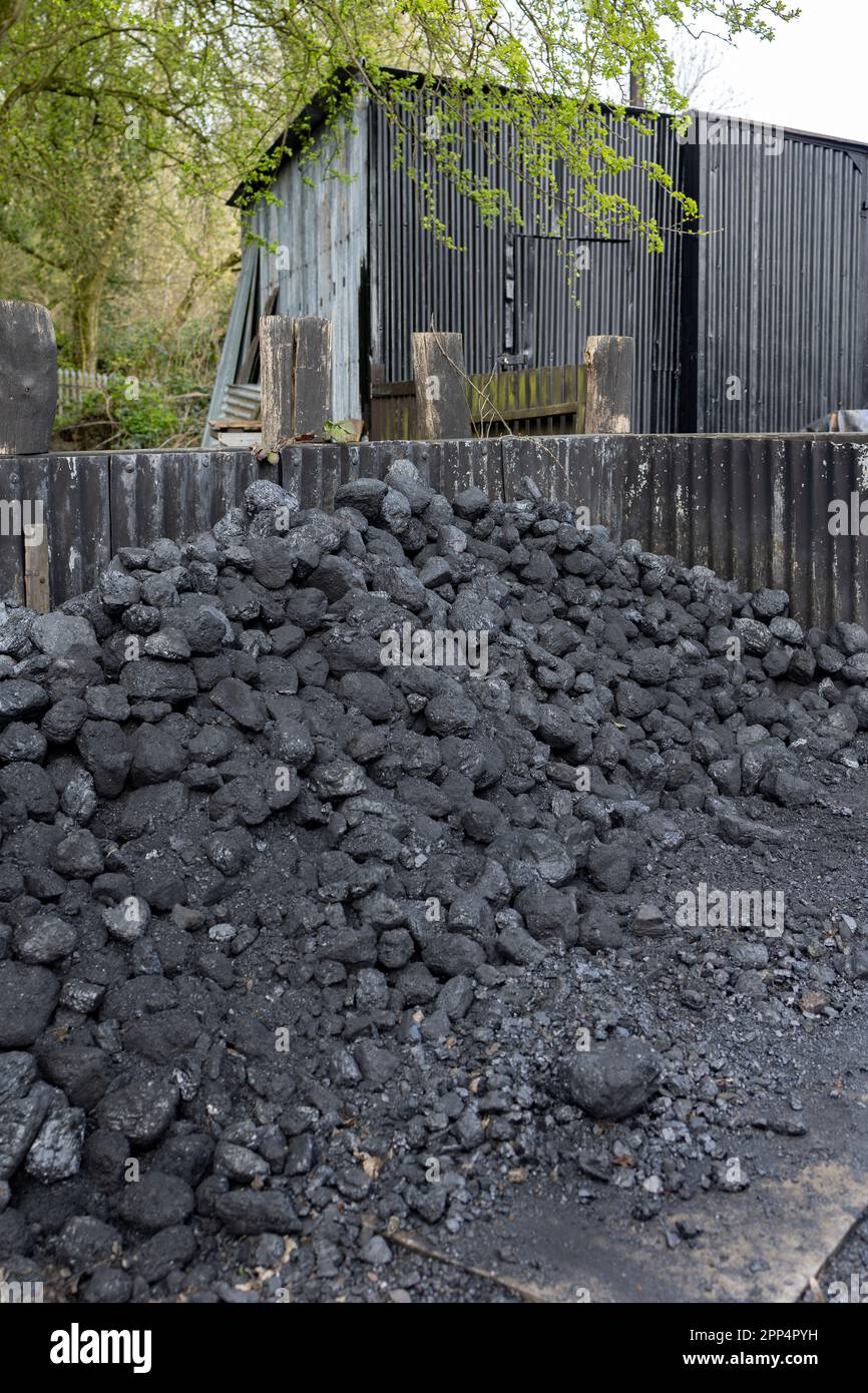 a pile of hard coal in front of the factory, supplies for the winter ...