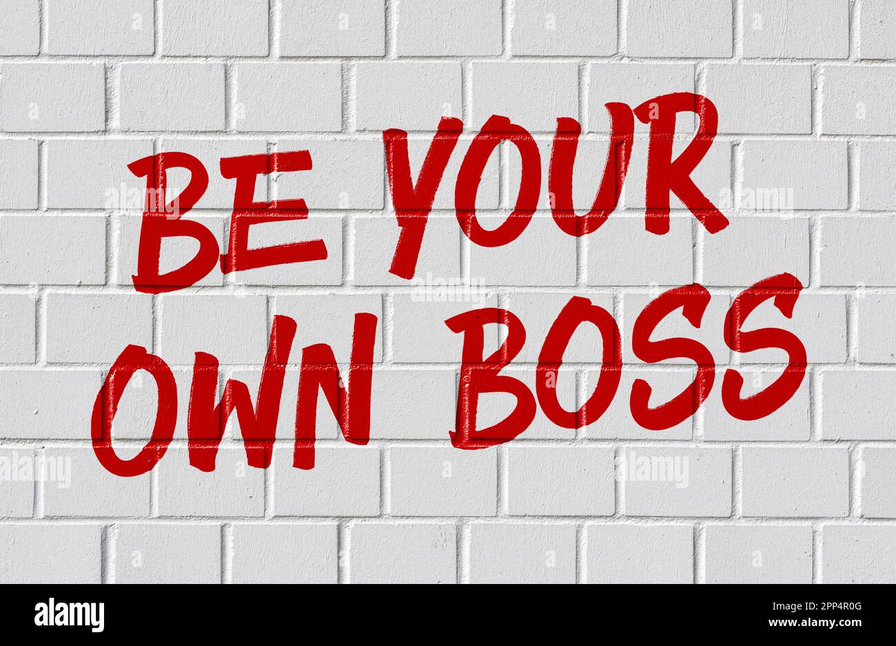 Graffiti on a brick wall - Be your own Boss Stock Photo - Alamy
