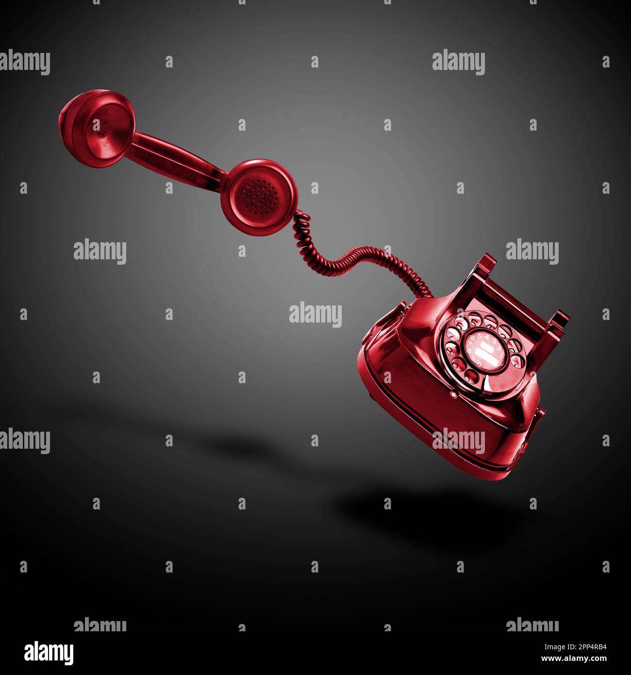 Floating Old Red telephone with shadow against black radial gradient ...