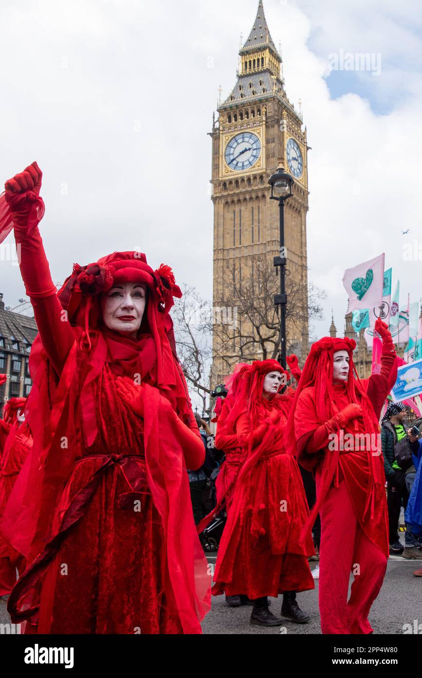 London, UK. 21st April, 2023. Extinction Rebellion Red Rebels pass the ...