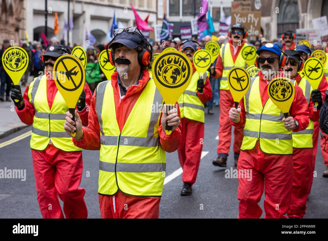 London, UK. 21st April, 2023. Climate activists dressed as air marshals ...