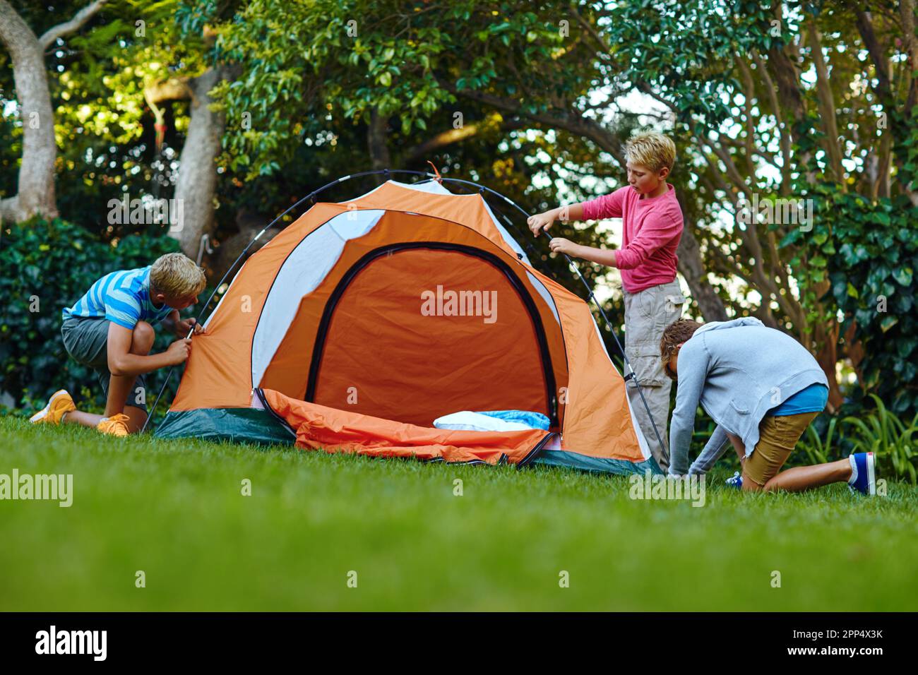 This will be their home for the night. three young boys putting up ...