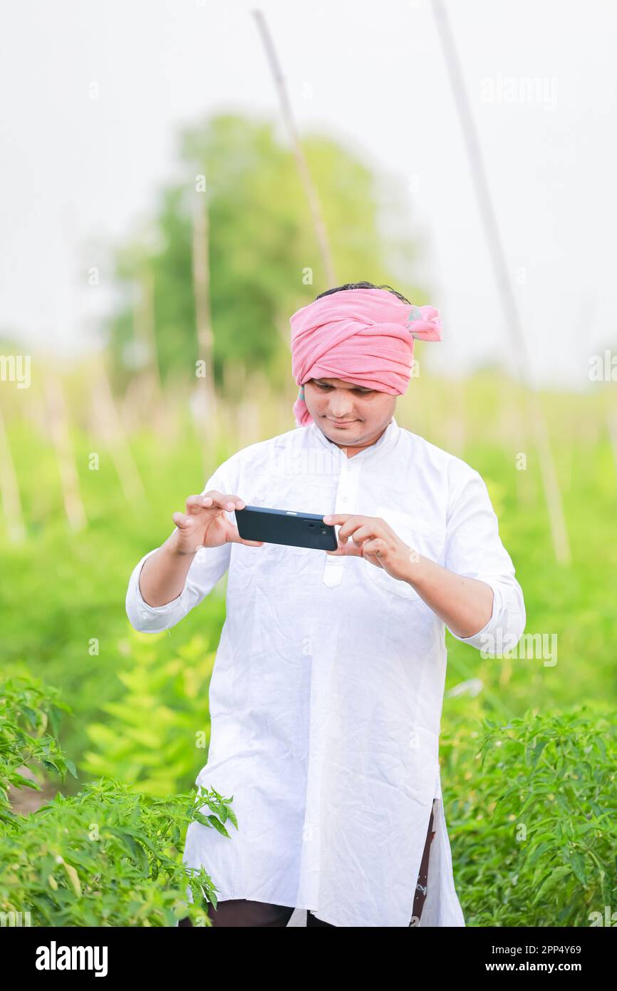 Young indian farmer showing Smart phone , Farmer talking on phone in ...