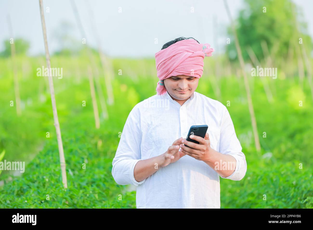 Young indian farmer showing Smart phone , Farmer talking on phone in ...