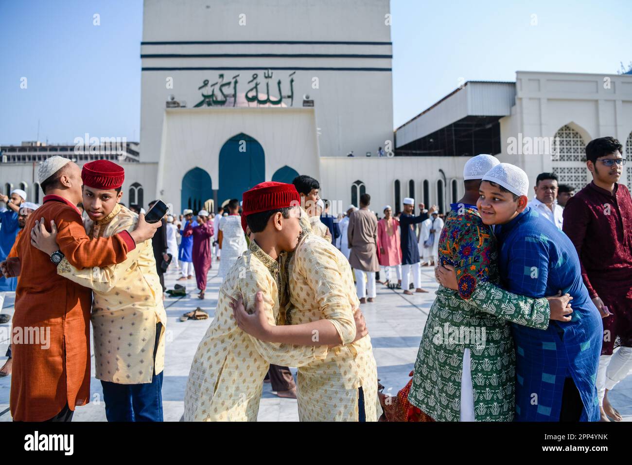 Muslim men hug each other in greeting after Eid al-Fitr prayers at ...
